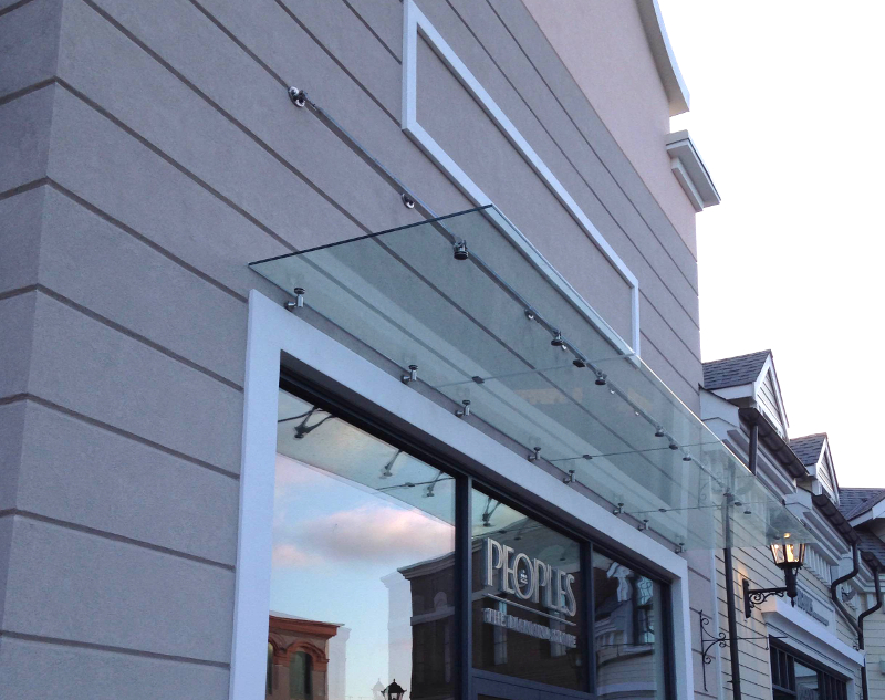 Glass canopy system by Angel Glass. Custom glass canopy and metals.